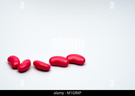 red sugar coated pills tablets vitamin on white background Stock Photo ...