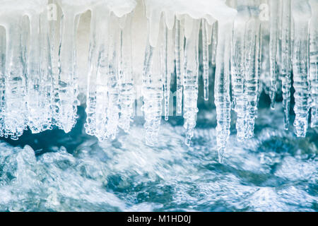 A beautiful frozen icicles at the bank of river in Latvia. Beautiful ...