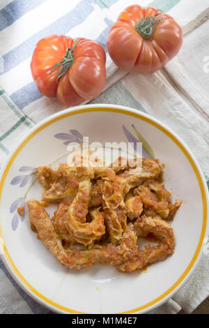dish of tripe roman style with nearby two fresh tomatoes Stock Photo ...
