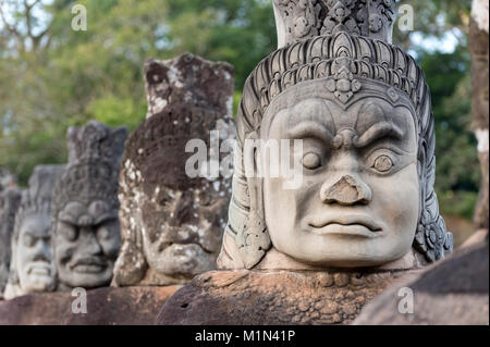 Close up of Asuras (Demons) statues in a row at the south entrance gate ...