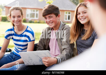 Group Of Teenage Students Collaborating On Project In Classroom Stock ...