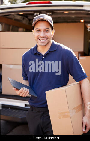 Portrait Of Courier With Digital Tablet Delivering Package Stock Photo ...