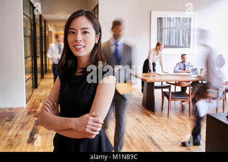 Young adult Asian woman professional writing notes in journal at desk ...