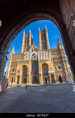 Lincoln Cathedral viewed through archway of Exchequer Gate at dusk ...