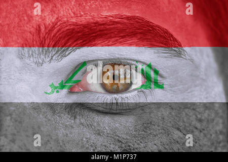 A young man with painted Iraqi flag on his face celebrates in streets ...