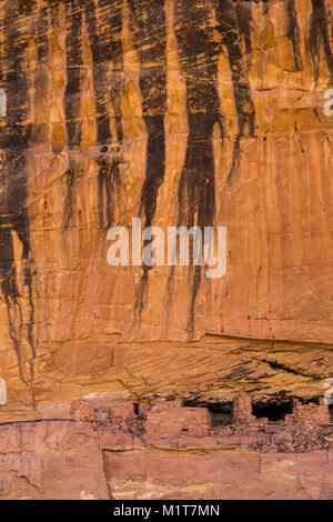 Desert varnish runs down the cliff above Big Ruin, an Ancestral Pueblo ...