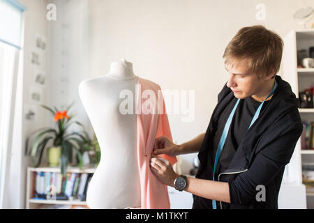 fashion designer with dummy making dress at studio Stock Photo - Alamy