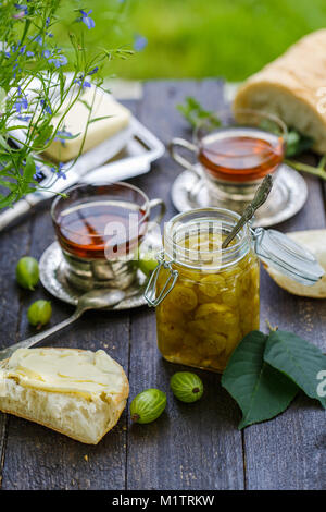 Gooseberry jam and fresh berries, on a light wooden background Stock ...