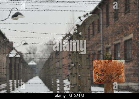 Vorsicht warning sign near barbed wire fences and barriers inside ...