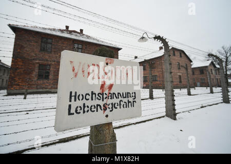 Vorsicht warning sign near barbed wire fences and barriers inside ...