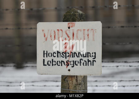 Vorsicht warning sign near barbed wire fences and barriers inside ...