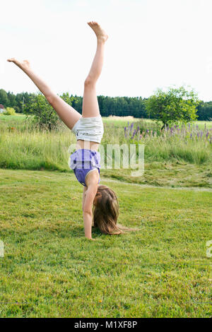 girl doing cartwheel in the grass Stock Photo - Alamy