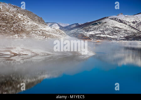 Winter Morning and reflection of mountains at Riaño reservoir in Spain ...