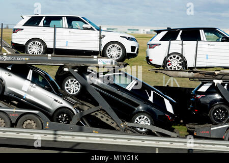 New Land Rover cars carried on a car transporter lorry, Birmingham, UK ...