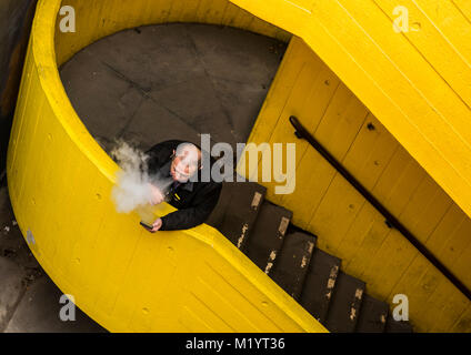 Man leaning on a wall, smoking Stock Photo - Alamy