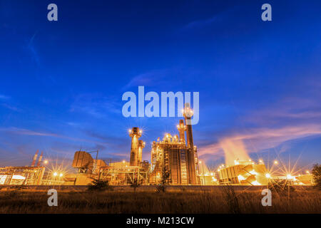 Natural gas combine electric power plant at night in industrial estate ...