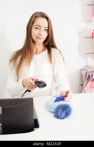Seller holding barcode scanner in a hand Stock Photo - Alamy