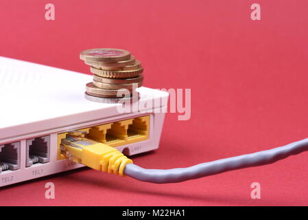 Coins and network router, paid access to the network Stock Photo - Alamy