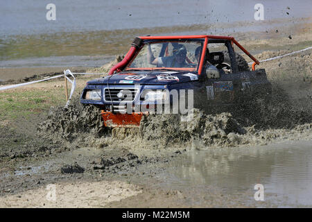 Offroad car is driving through mud and water Stock Photo - Alamy