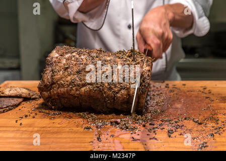 Chef Carving Juicy Roast Meat in a Bright, Modern Kitchen Environment ...