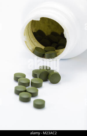 close up of a group of fermented chlorella tablets isolated on a white ...
