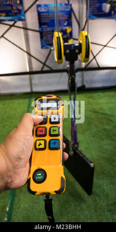 Operator controlling a industrial crane with remote control in a ...