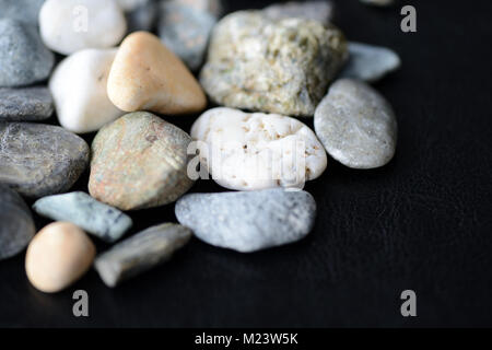 Scattered stones on a dark background close up. Black and white Stock ...