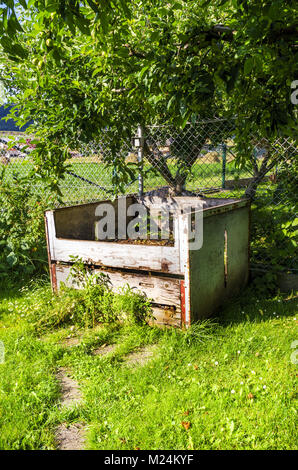 Composting in the garden under the tree Stock Photo - Alamy