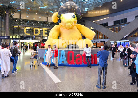 Main area of Hamad International Airport, with the giant yellow teddy ...