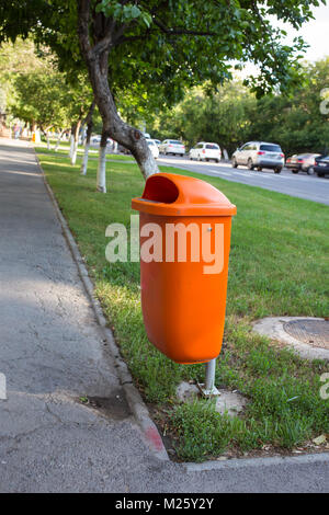 Orange plastic waste bin isolated on white Stock Photo - Alamy