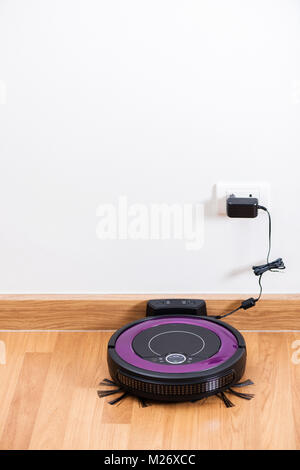robotic vacuum cleaner charging battery at charging dock Stock Photo ...