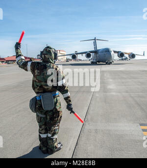 An Airman from the 860th Aircraft Maintenance Squadron brings a ...