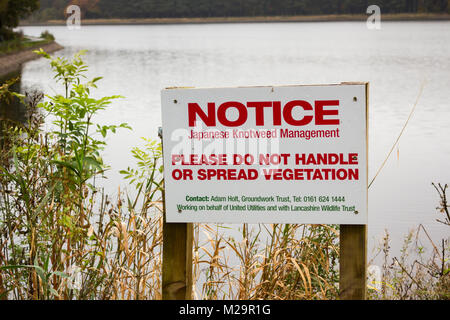 A sign warning of Japanese knotweed and warning of controlled entry ...