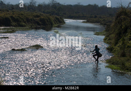Men belonging to Tharu community fish in the Rapti river in Sauraha ...
