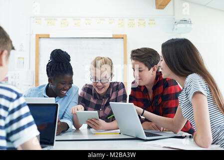 Group Of Teenage Students Collaborating On Project In Classroom Stock ...