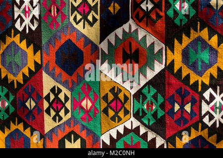 Traditional Turkish rug textile with patterns in bazaar Stock Photo - Alamy
