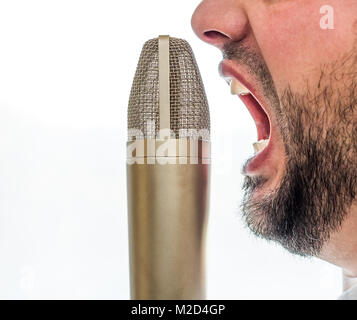Metal singer yelling into the microphone with mouth wide open and eyes ...