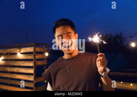 Young men set off fireworks Stock Photo - Alamy