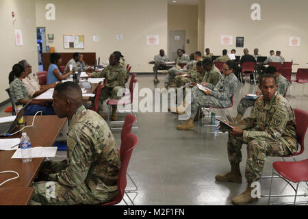 Soldiers of the 104th Troop Command sit in different stations awaiting ...