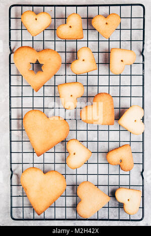 Grid with tasty heart shaped cookies on color background, closeup ...