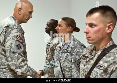 Gen. Raymond Odierno presents Spc. Jeremy Dye his coin. Spc. Jeremy Dye ...