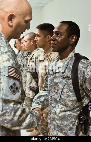 Gen. Raymond Odierno presents Sgt. Jeremiah Fogle his coin. Sgt ...