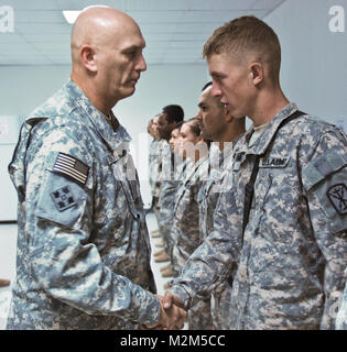 Gen. Raymond Odierno presents Spc. Jeremy Dye his coin. Spc. Jeremy Dye ...