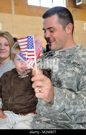 An Iraqi National Guard soldier waves Iraqi flags which were supplied ...