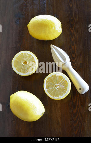 Composition with lemon juice and squeezer on wooden background Stock ...