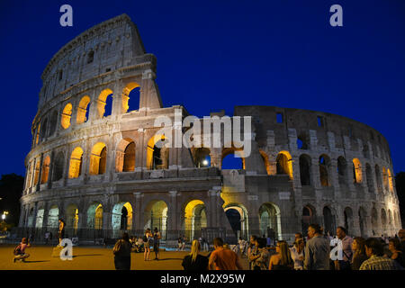 People walk past the ancient Colosseum as they take part in the Pride ...