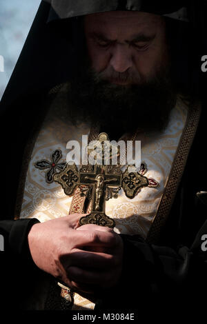 A Bulgarian orthodox cleric holding a crucifix during a religious mass ...