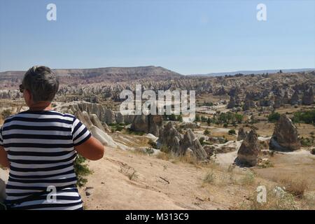 Tourists visiting some of the famous Fairy chimneys in Cappadocia which ...