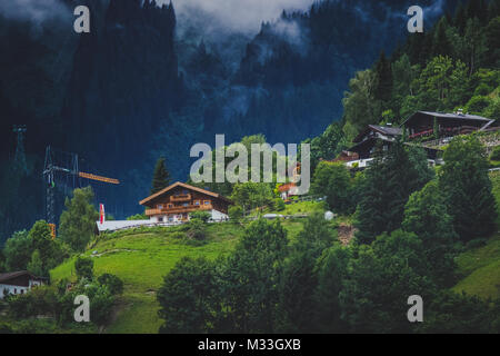 Alpine homes on the mountainside of Zell am See Lake, Austria, Europe on a rainy day Stock Photo ...