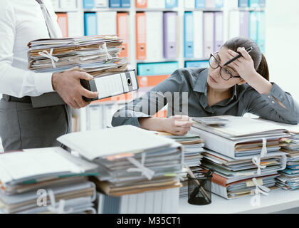 Messy business office desk with piles of files and disorganized clutter ...